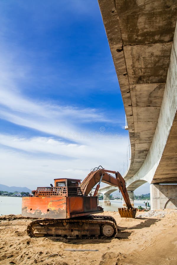 Excavator under a Bridge stock photo. Image of excavate - 27279112