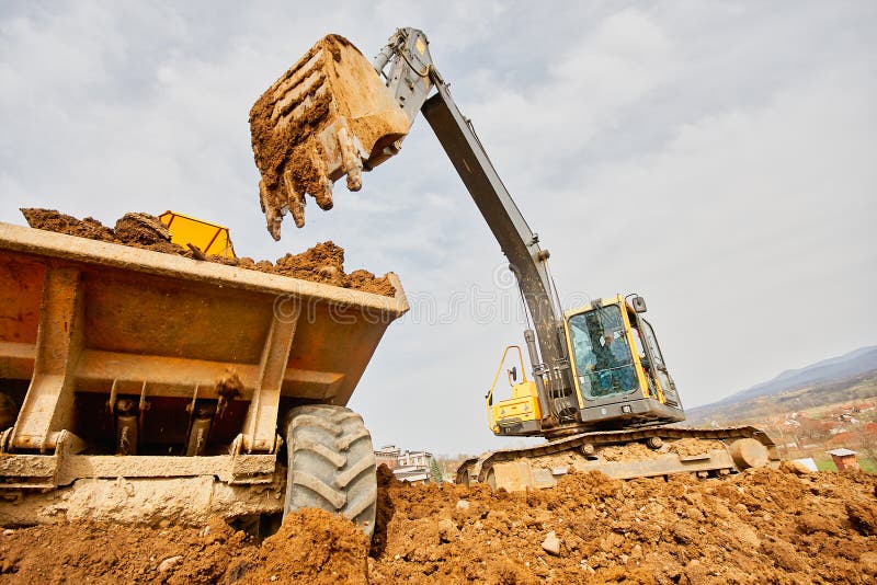 Excavator loading truck stock image. Image of construction - 67945417