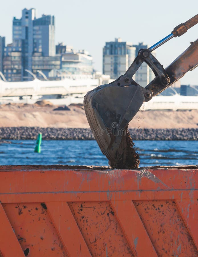 Excavator Unloading Sand into the Dump Truck on the Construction Site ...