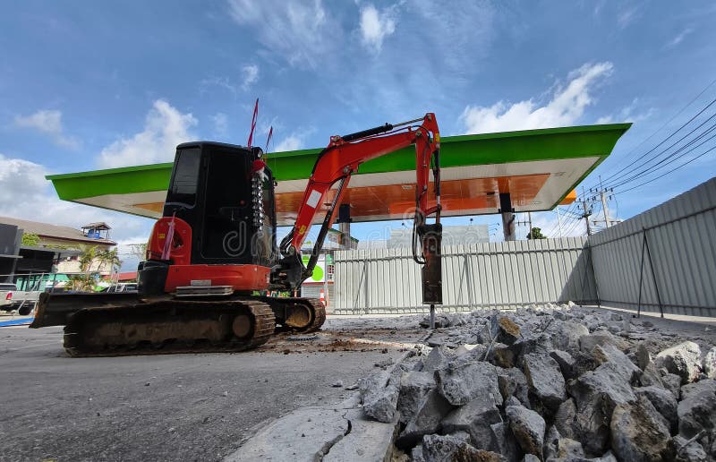 Excavator Using Hydraulic Hammer for Breaking Concrete at a ...
