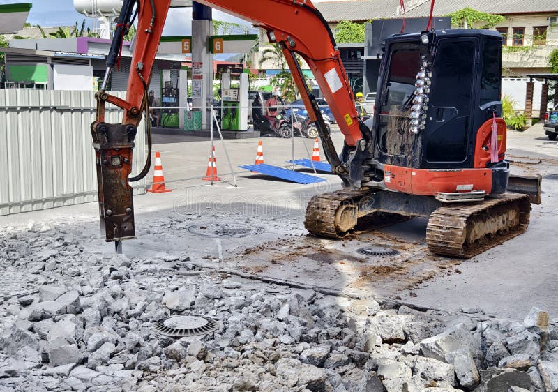 Excavator Using Hydraulic Hammer for Breaking Concrete at a ...