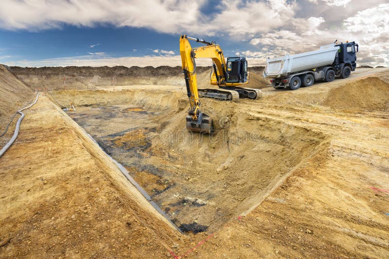 Excavator is Digging and Loading at Construction Site Stock Photo ...