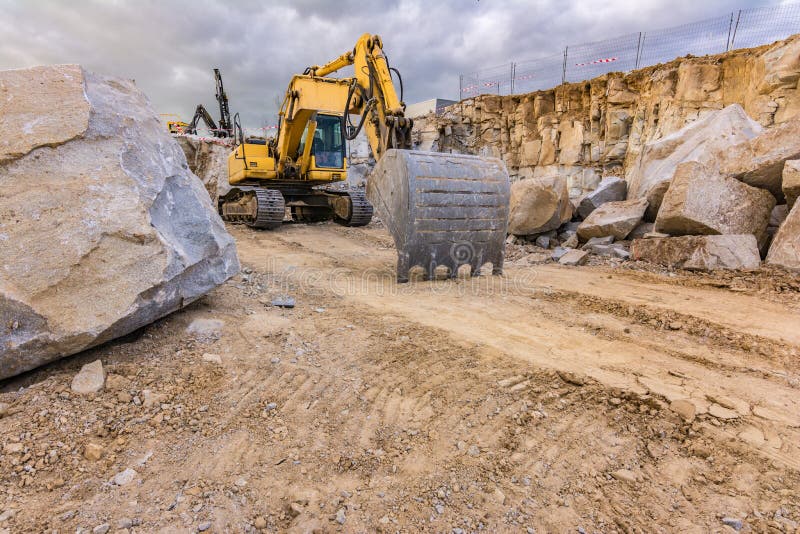 Excavator in a Work Extracting Granite To Transform into Gravel Stock ...