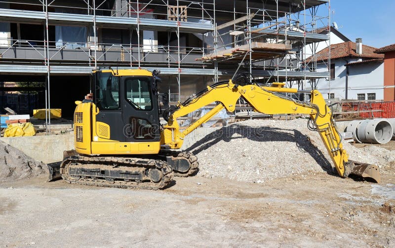 Excavator at Work in Front of Residential Building Under Construction ...