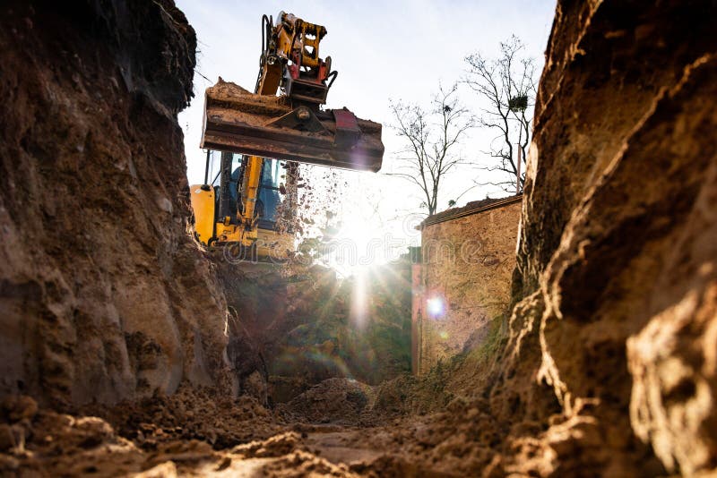 Excavator at Work Seen from Inside the Trench Stock Photo - Image of ...