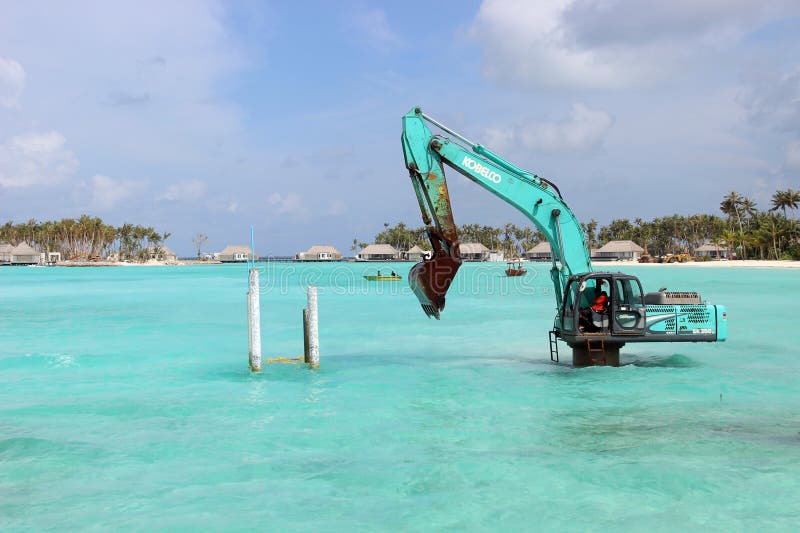 An Excavator Working on the Construction of a Resort. Stock Photo ...