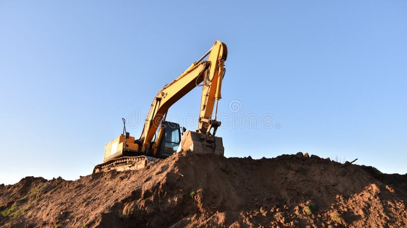 Excavator Working at Construction Site. Backhoe Digs Ground in Sand ...