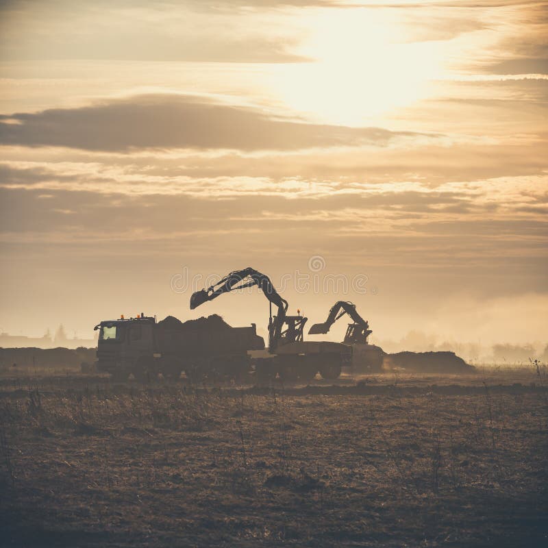 Excavator Working on Construction Site, Loading Dump Track Stock Image ...