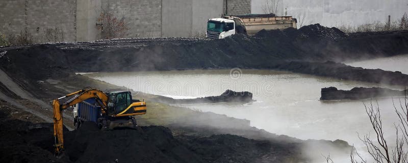 An Excavator is Working Digging Soil in a Pit Stock Image - Image of ...