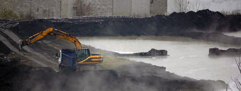 An Excavator is Working Digging Soil in a Pit Stock Photo - Image of ...