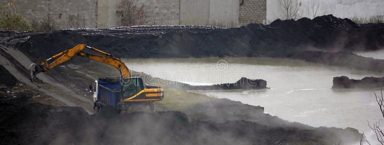 An Excavator is Working Digging Soil in a Pit Stock Photo - Image of ...