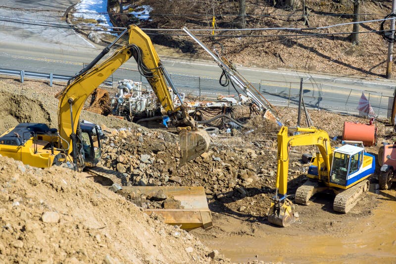 An Excavator Working on Earthwork at a Industrial Site Under ...