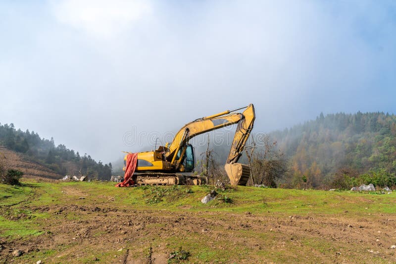 Excavator Working in the Field and Digging the Earth Stock Image ...