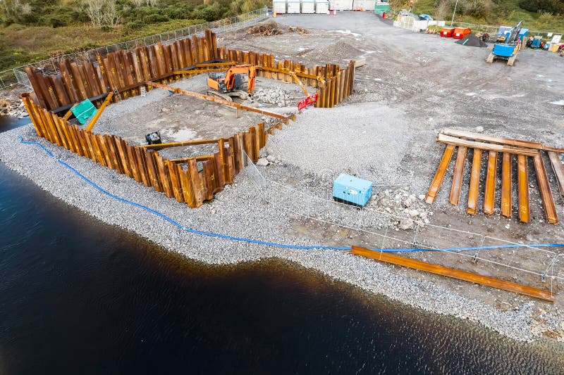 Excavator Working in Metal Frame Structure by a River. Construction ...