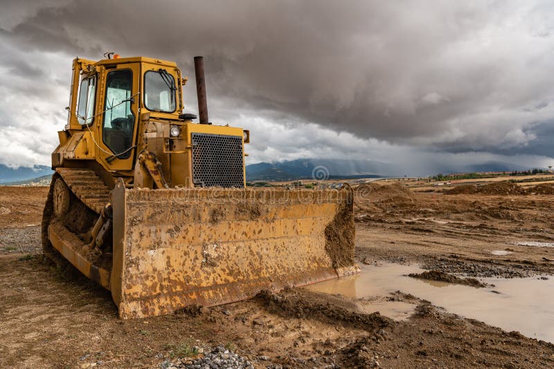 Excavator Working on a Muddy Construction Site Stock Photo - Image of ...
