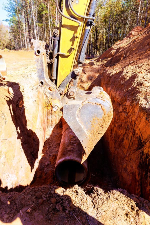 Excavator Working on Pipeline Installation in a Rural Area during ...