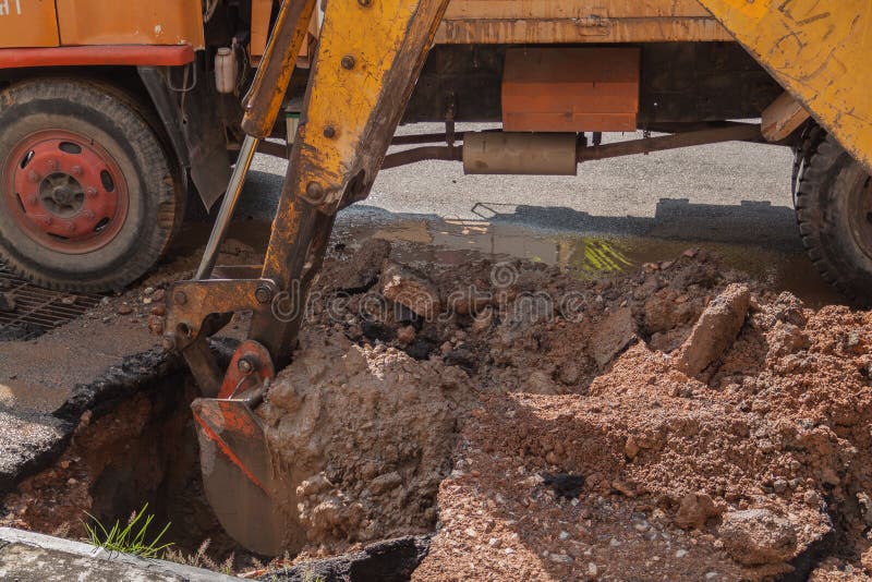 Excavator Working on the Repair of Pipe Water on Road Stock Image ...