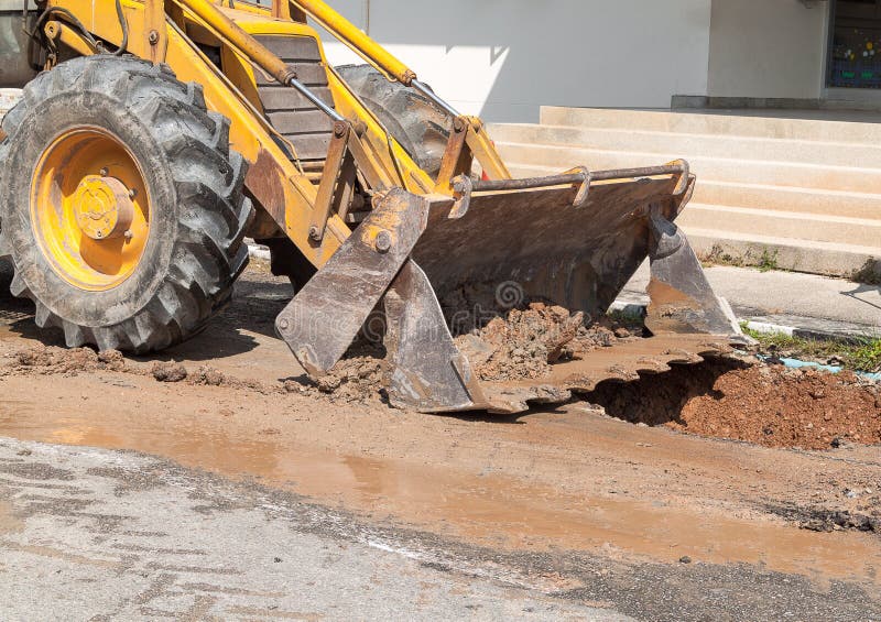 Excavator Working on the Repair of Pipe Water and Sewerage on Road ...