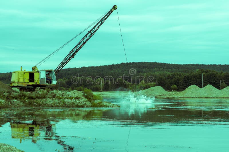 Excavator Working in the River Gravel Quarry Against the Background of ...