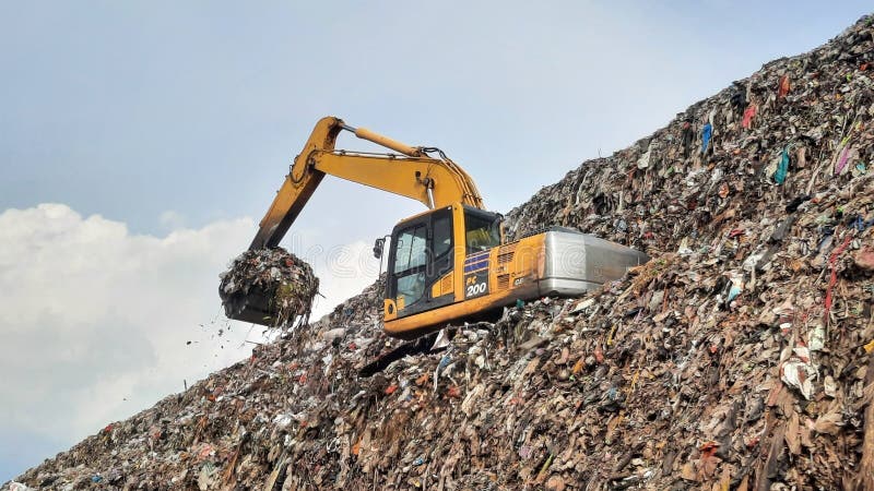 Excavator Working on Towering Trash Piles in Landfill Stock Image ...