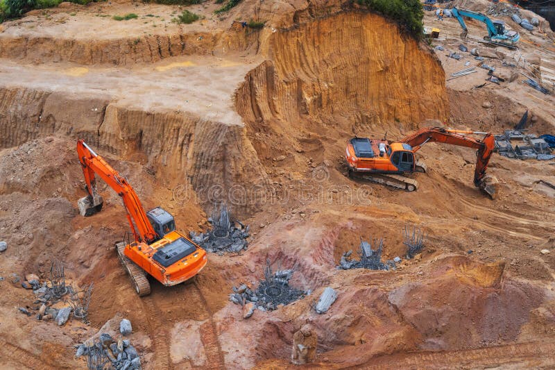 Excavators Dig the Ground in Foundation Pit of a Building on a ...