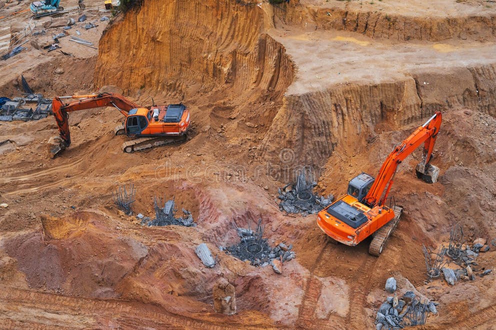 Excavators Dig the Ground in the Foundation Pit of Building on a ...