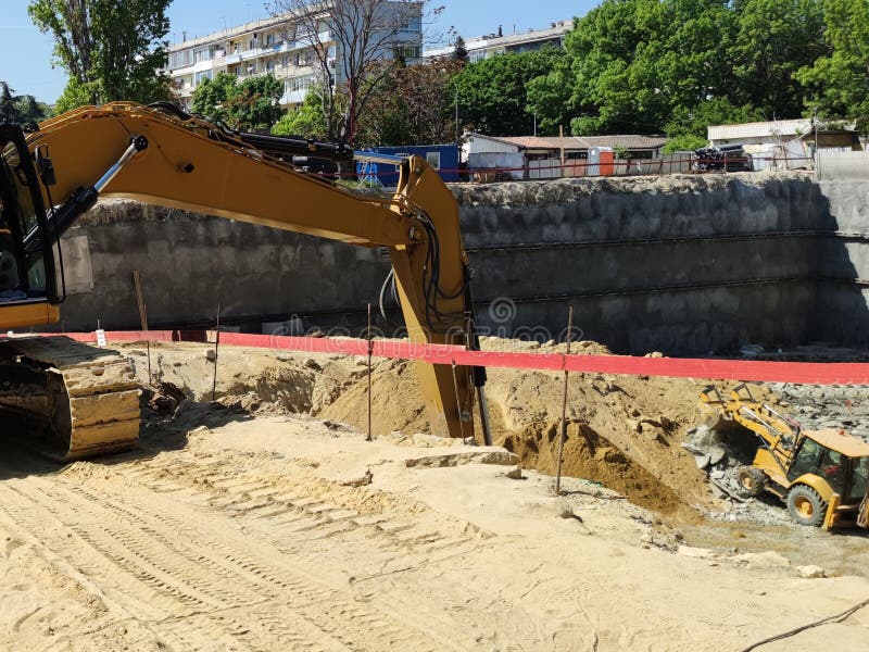 Excavators are Digging a Foundation Pit for a Large Building Stock ...