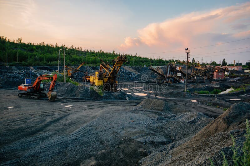 Excavators and Dump Trucks Working on Earthmoving at Open Pit Mine in ...