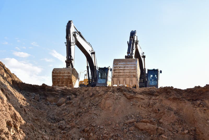 Excavators during Earthworks at Construction Site. Backhoe the Digging ...