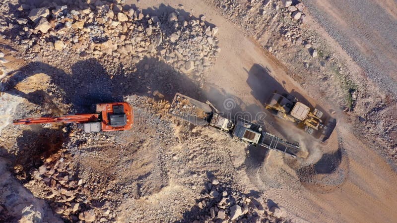 The Excavators Loading of a Stone in the Dump Trucks. Aerial View from ...
