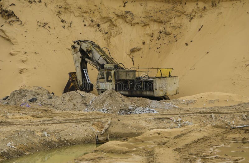 Excavators at a Sand Quarry. Big Orange Digger in Open Sand Mine is ...