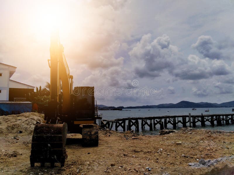 Excavators Work To Dig the Soil in a Beautiful Seaside View. Stock ...