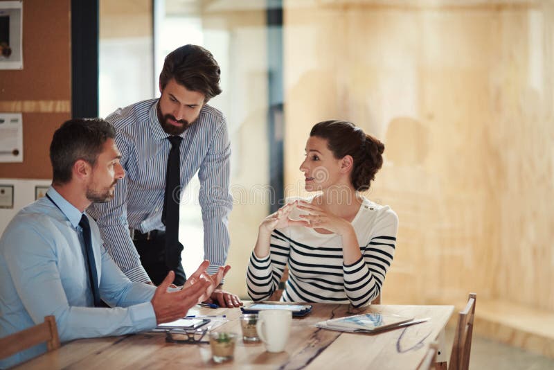 Exchanging Ideas with the Team. a Group of Colleagues Working Together ...