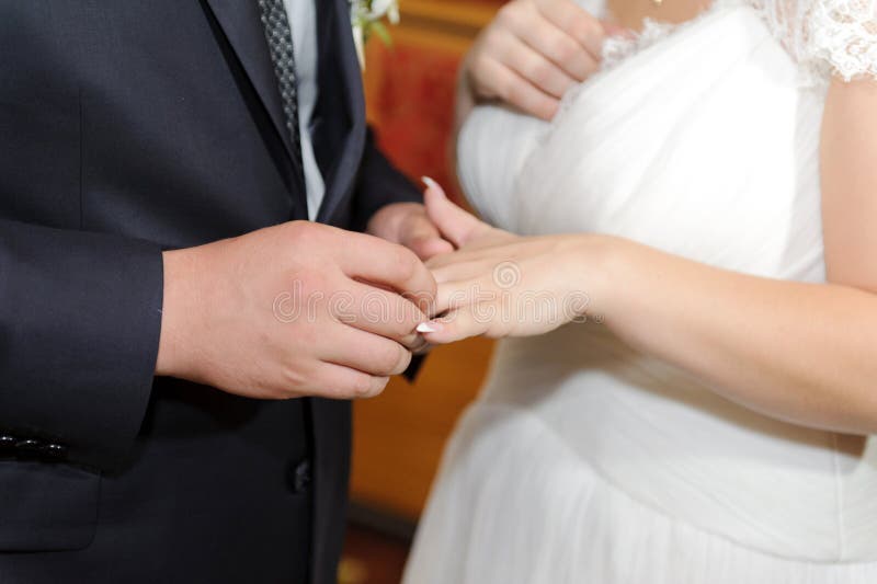 Newlywed Bride And Groom Exchanging Golden Wedding Rings At Ceremony ...