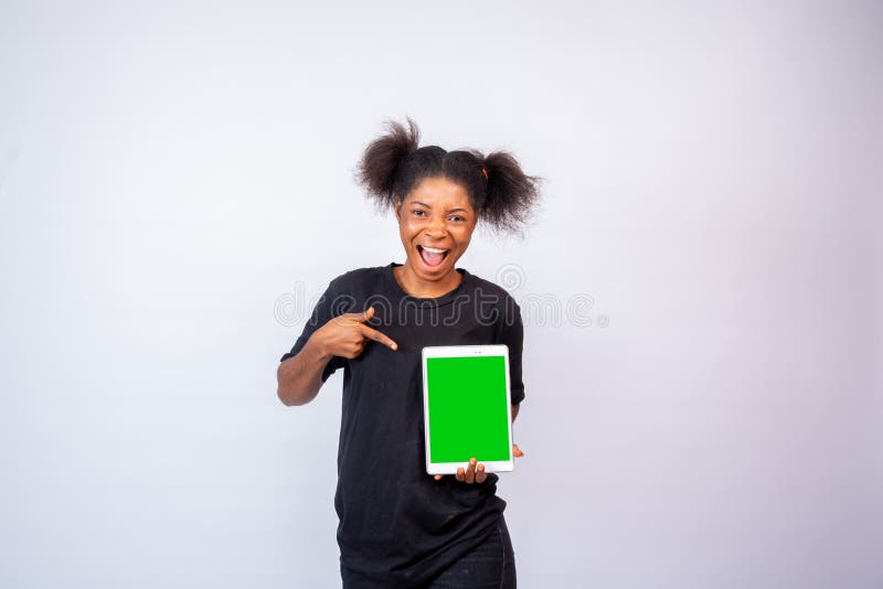 Excited African Lady Holding a Tablet Computer with the Screen Facing ...