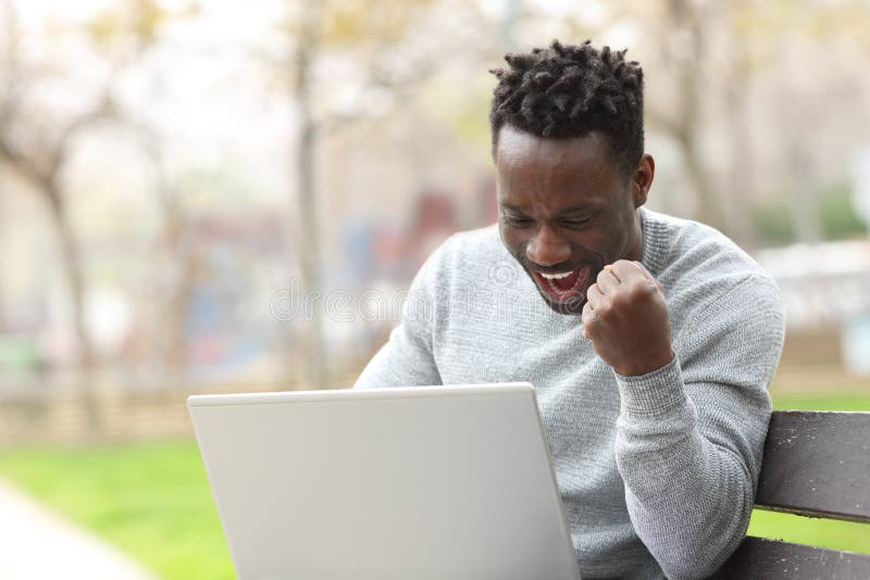Excited Black Man Checking Laptop in a Park Stock Image - Image of ...