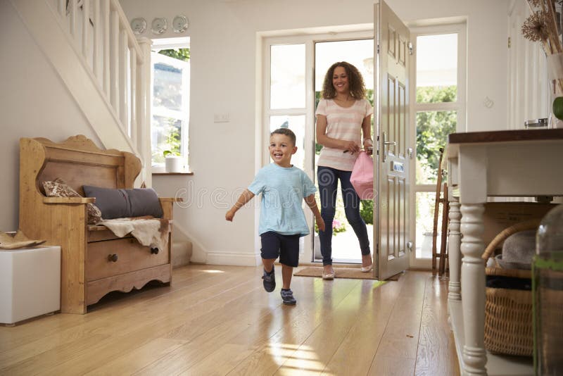 Excited Boy Returning Home from School with Mother Stock Image - Image ...