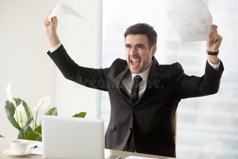 Excited Businessman Celebrating Business Success Holding Papers Stock