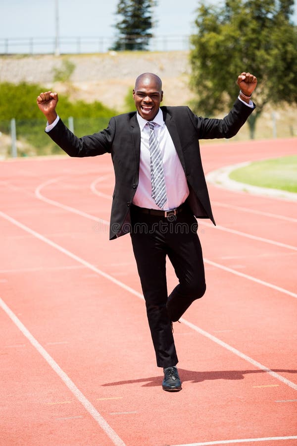 Excited Businessman Standing on the Running Track Stock Image - Image ...