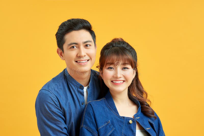 Excited Cheerful Young Couple Standing Isolated Over Yellow Background ... Excited Cheerful Young Couple Standing Isolated Over Yellow Background ...