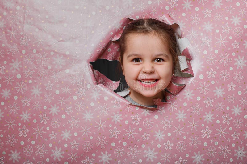Excited Child Peeking through Wrapping Paper Stock Photo - Image of ...