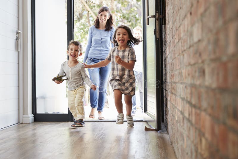 Excited Children Arriving Home with Parents Stock Photo - Image of ...