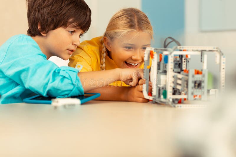 Excited Children Playing with the Robot at Science Class. Stock Photo ...