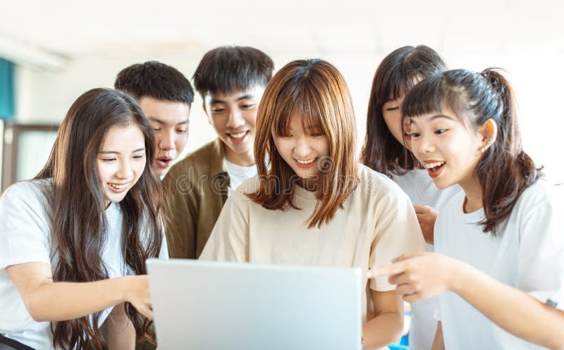 Excited College Students Looking at Laptop in Classroom Stock Image ...