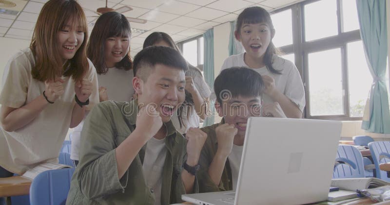 Excited College Students Looking at Laptop in Classroom Stock Footage ...