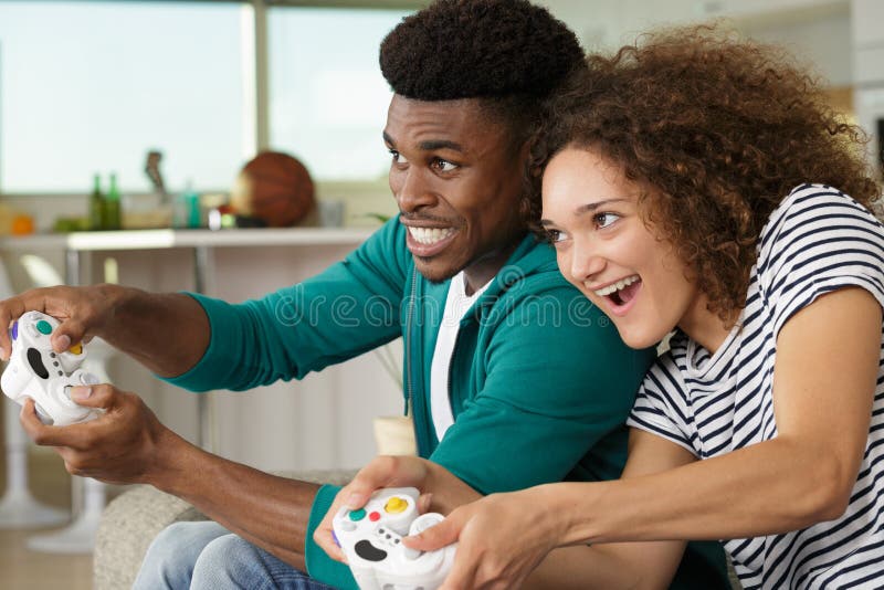 Excited Couple Playing Computer Game in Home Stock Photo - Image of ...