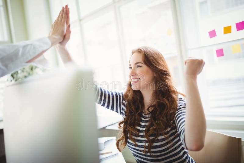 Excited Coworkers Giving High-five at Creative Office Stock Photo ...