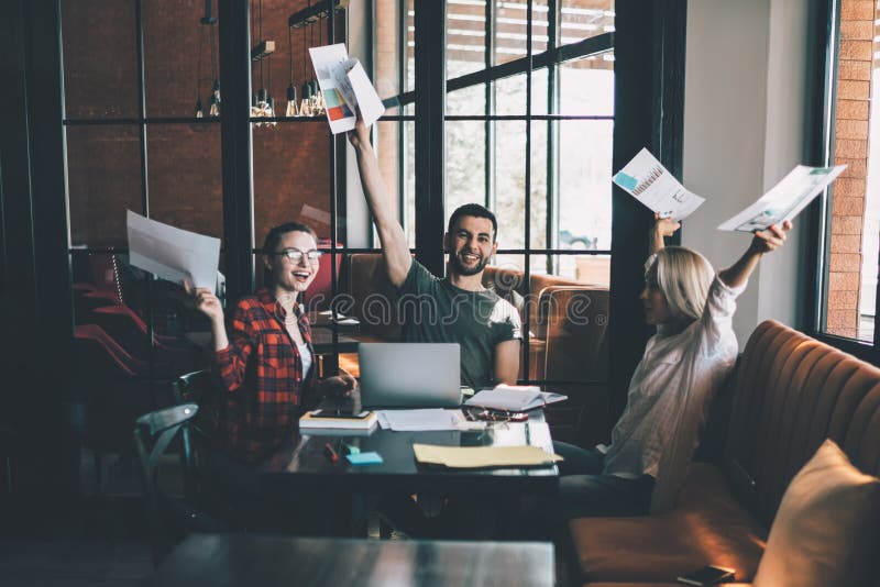 Excited Coworkers Holding Papers with Charts Stock Image - Image of ...