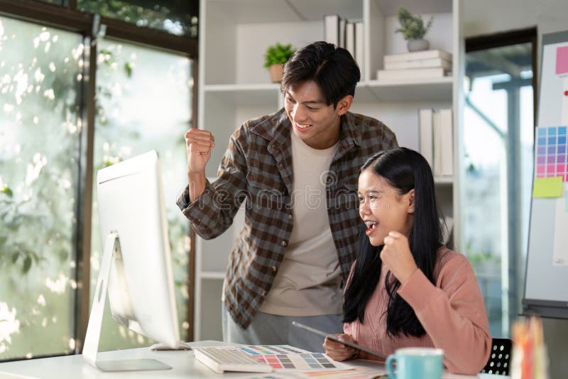 Excited Design Team Celebrating a Creative Breakthrough while Reviewing ...