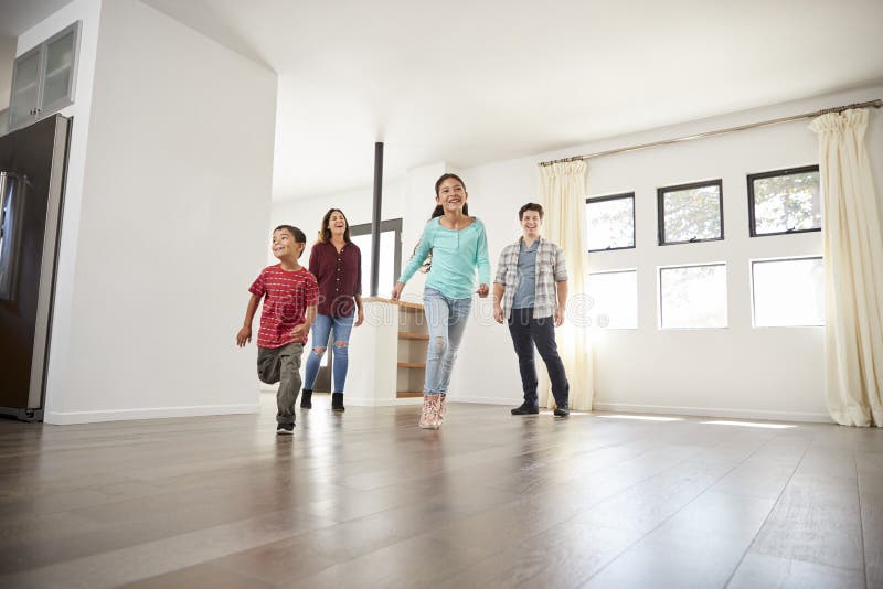 Excited Family Exploring New Home on Moving Day Stock Image - Image of ...